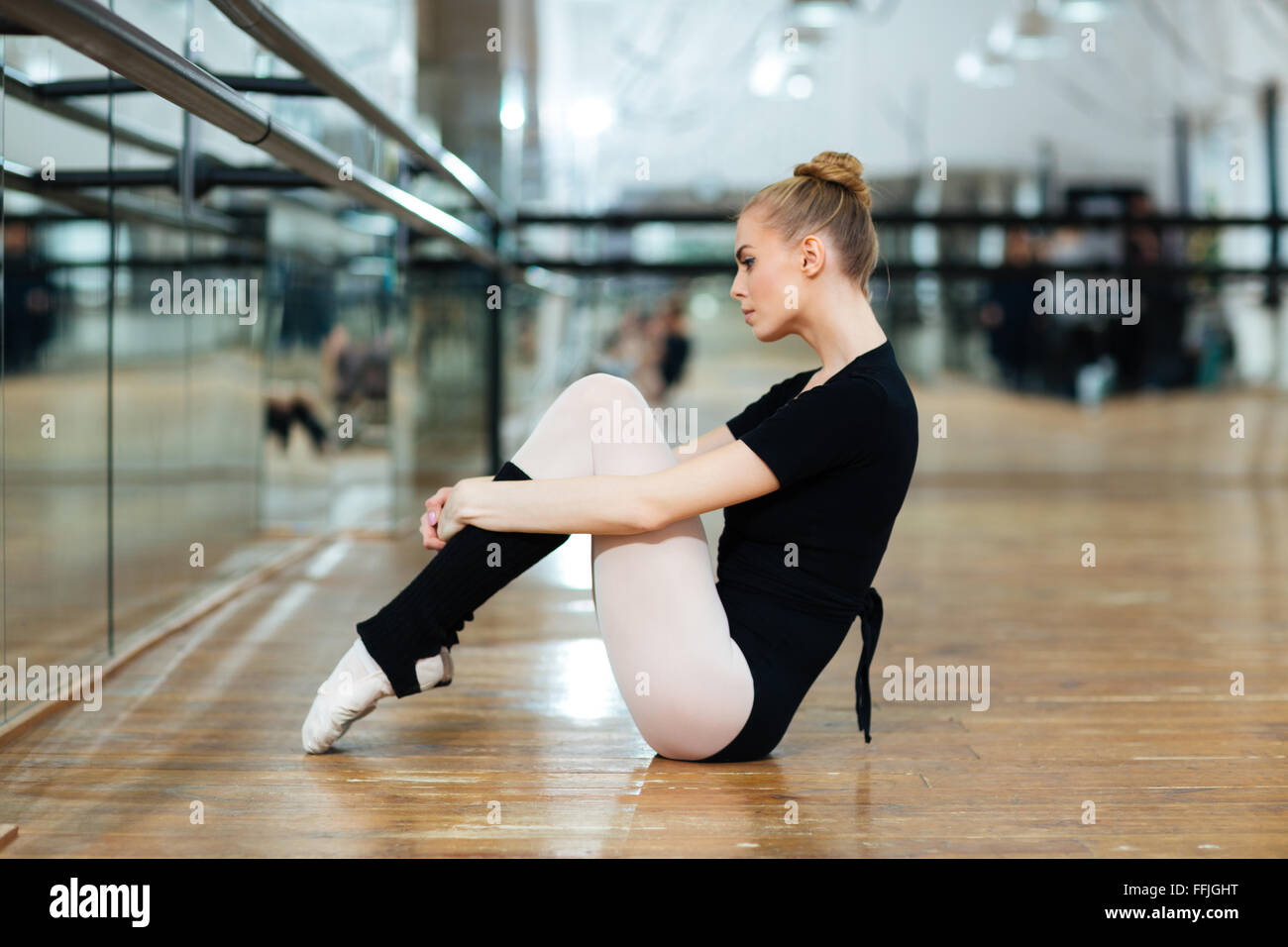 Ballerina resting on the floor in ballet class Stock Photo - Alamy