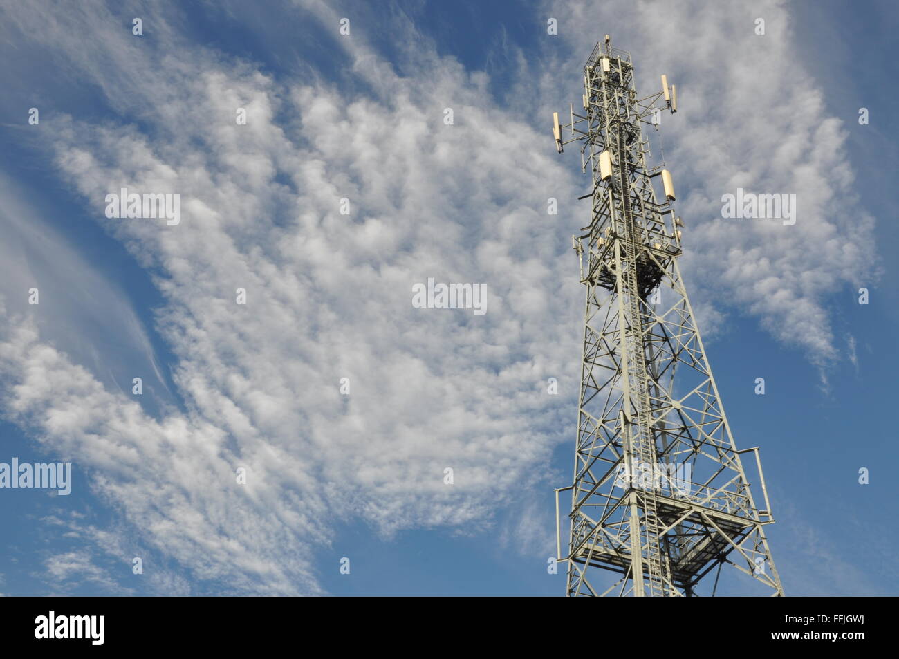 Telecommunication tower against cloudy sky Stock Photo - Alamy