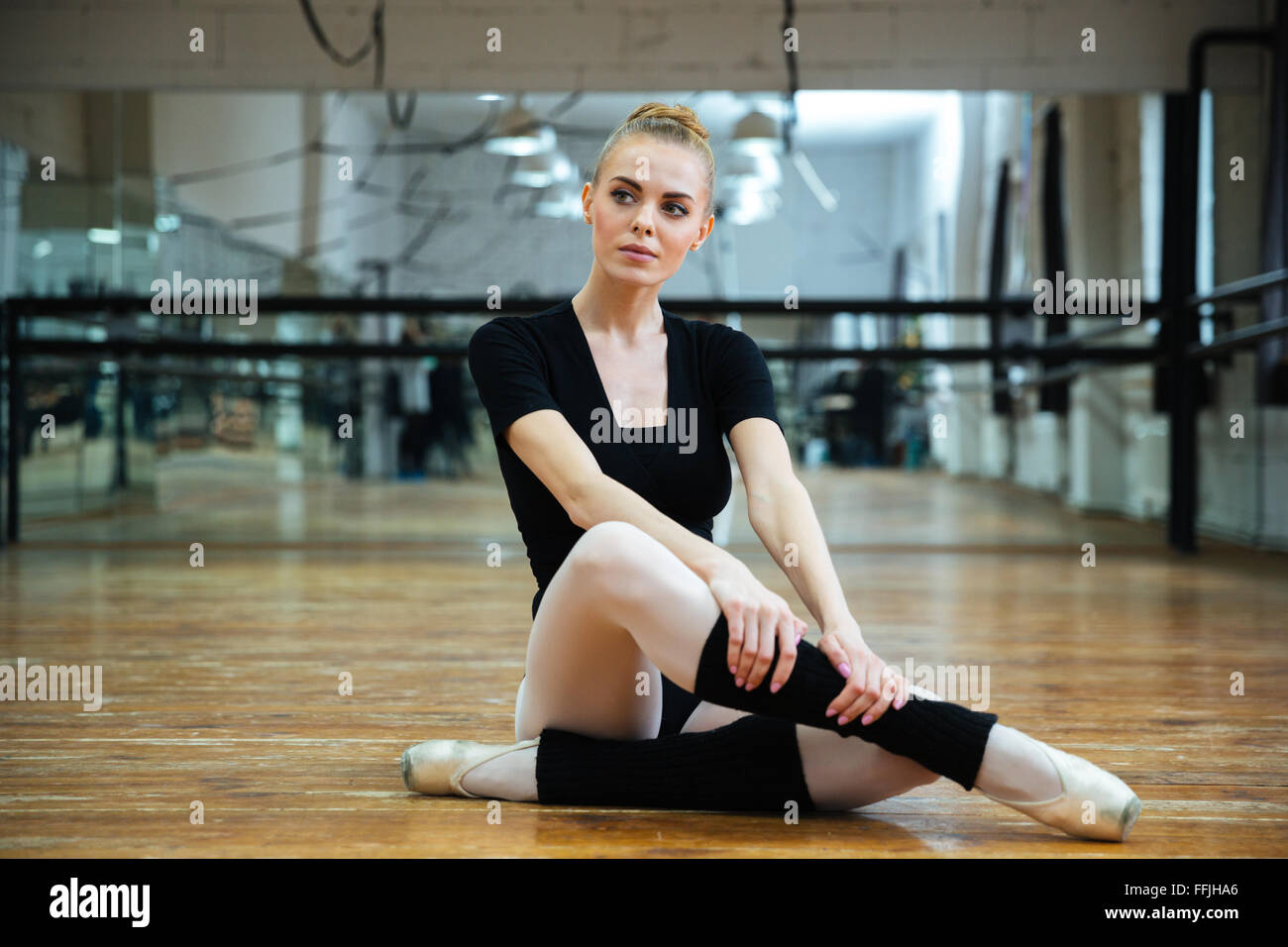 Ballerina resting on the floor in ballet class Stock Photo - Alamy