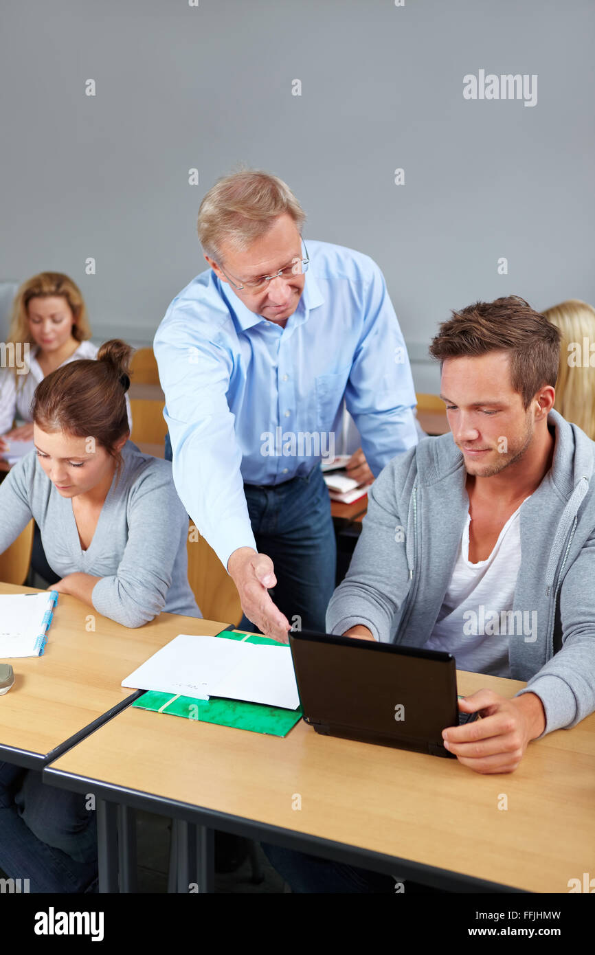 Teacher and college student in a class Stock Photo - Alamy
