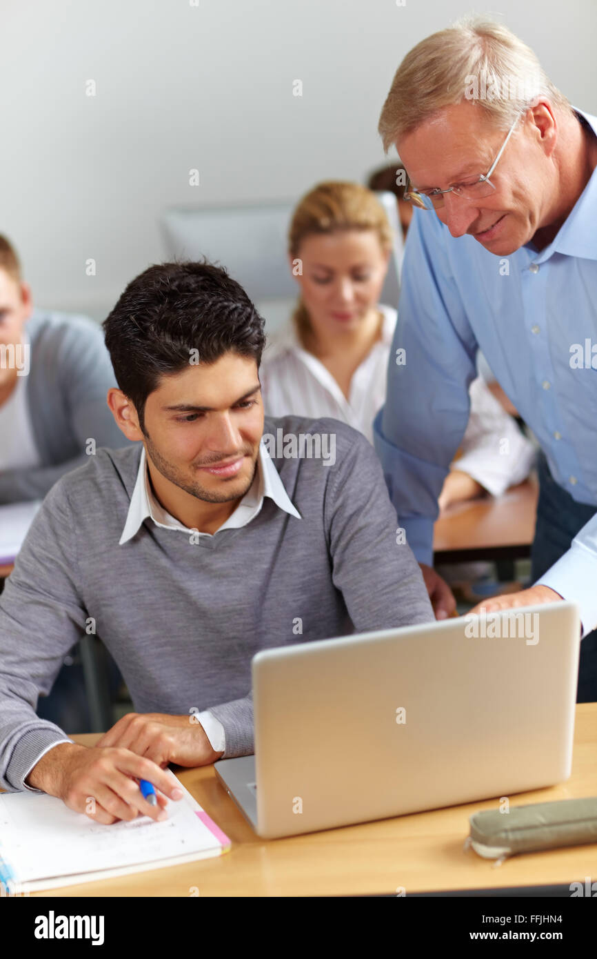 Assistance for student from teacher in university Stock Photo - Alamy