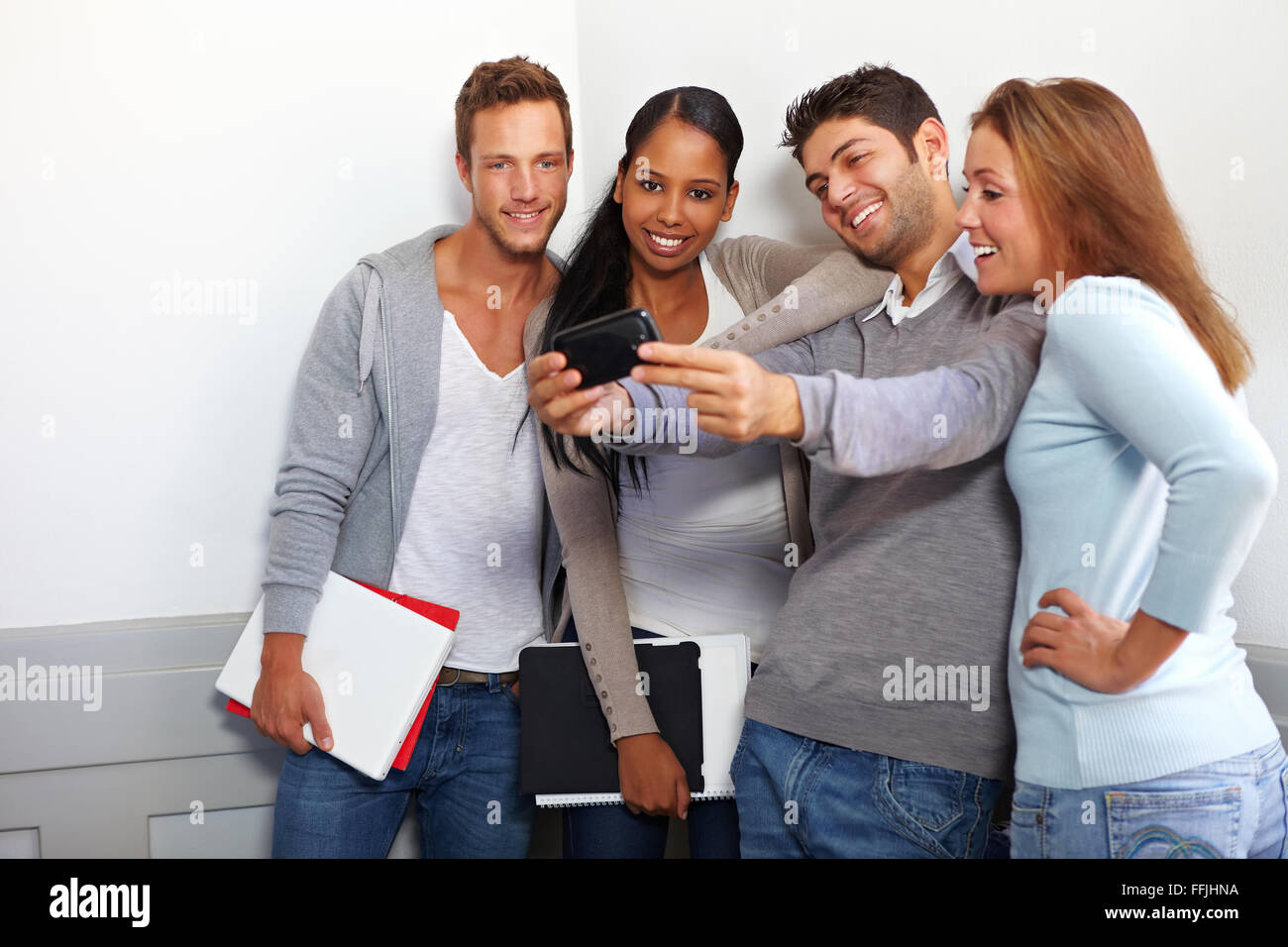Happy smiling students taking group photos with smartphone Stock Photo ...