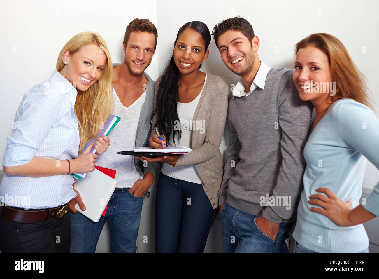 Portrait of happy smiling university students in the hall Stock Photo ...
