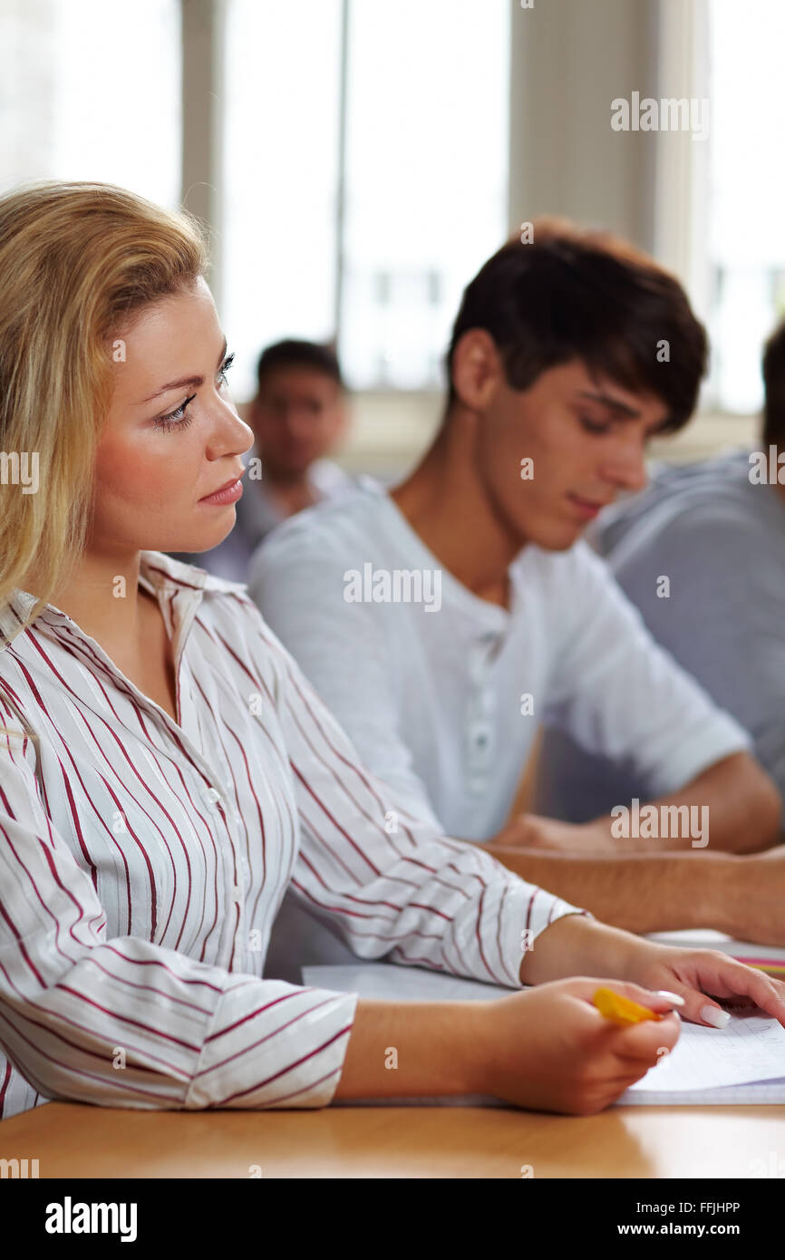 Female student in university class taking notes Stock Photo - Alamy