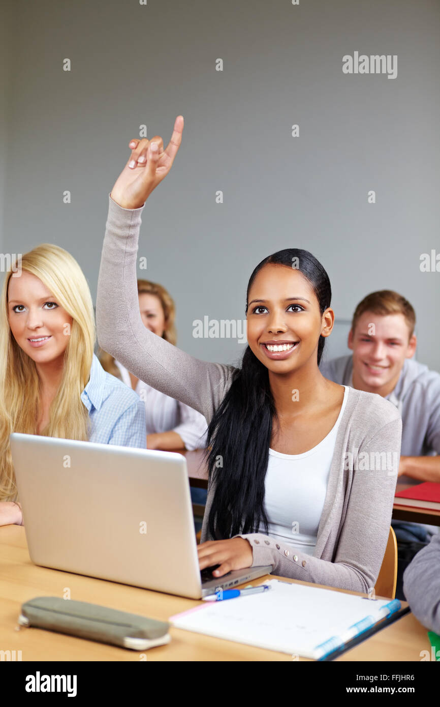 African student raising her hand in university class Stock Photo - Alamy