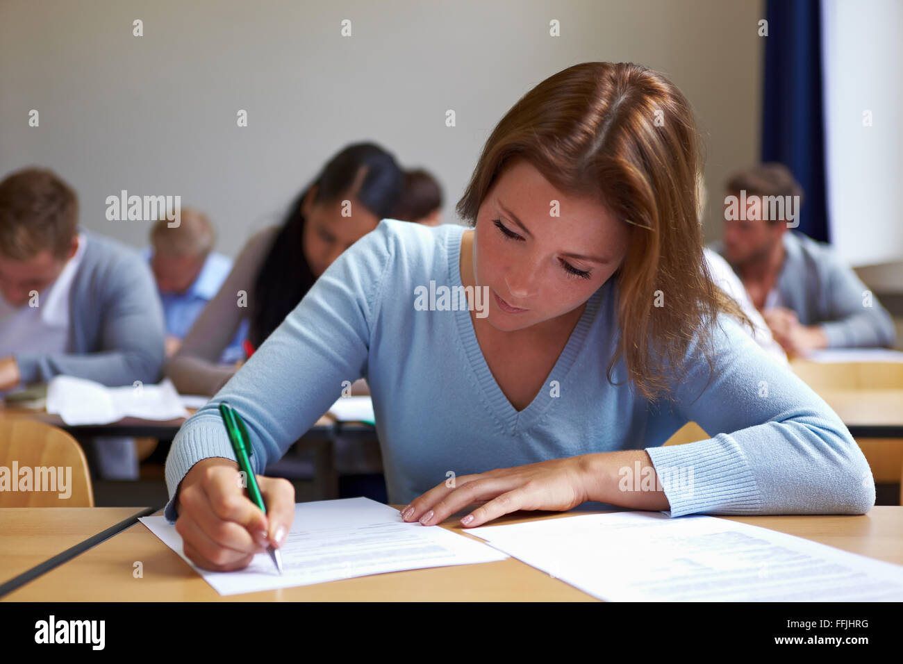 Young woman taking test in job assessment center Stock Photo - Alamy