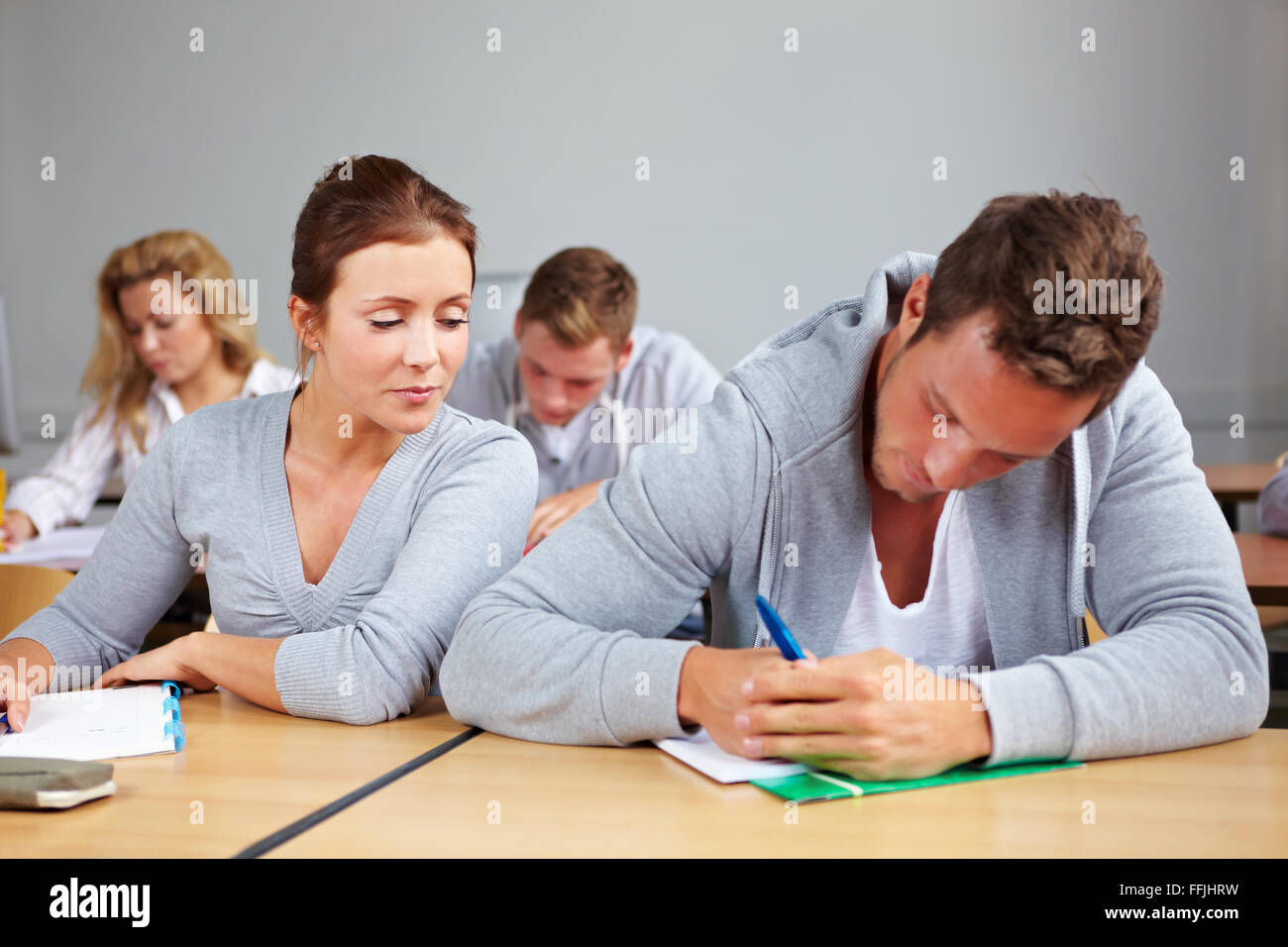Female student trying to cheat at test in class Stock Photo - Alamy