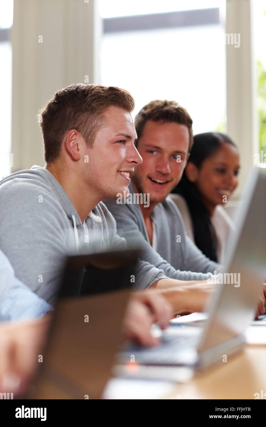 Happy young students smiling in university class Stock Photo - Alamy