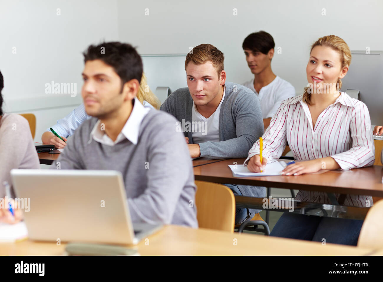 Many students learning in a university class Stock Photo - Alamy