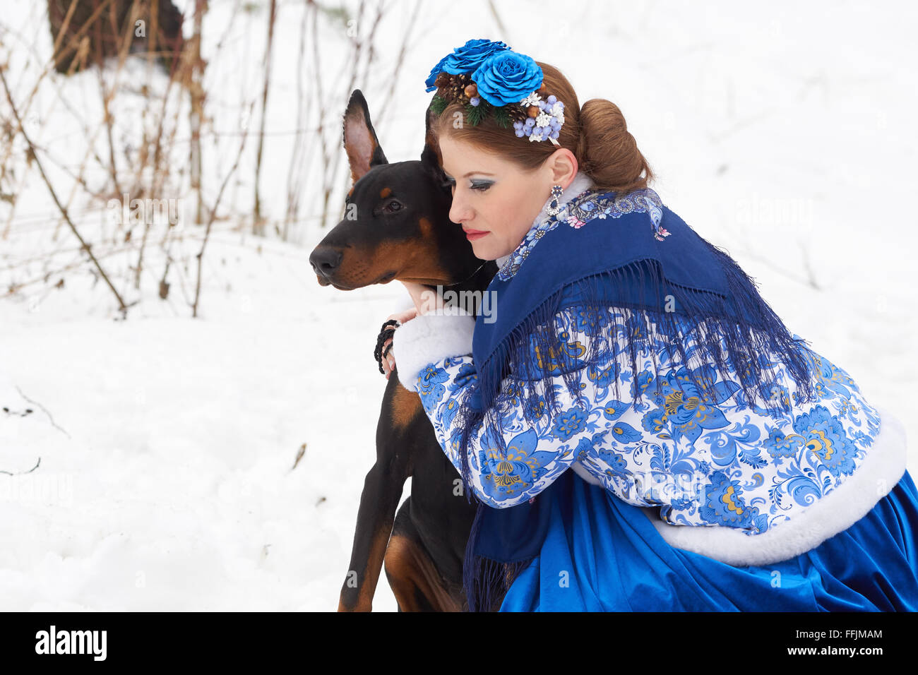 Young russian woman in traditional winter clothing lovely emracing ...