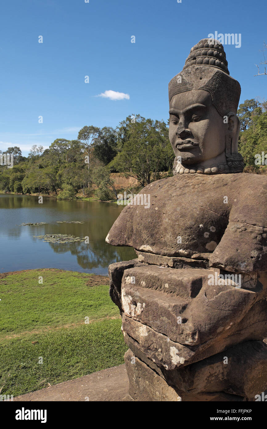 Deva (god) statue on the parapet of the south bridge into Angkor Thom ...