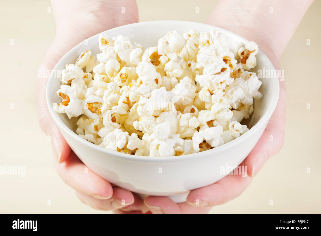 Hands holding bowl of popcorn Stock Photo - Alamy