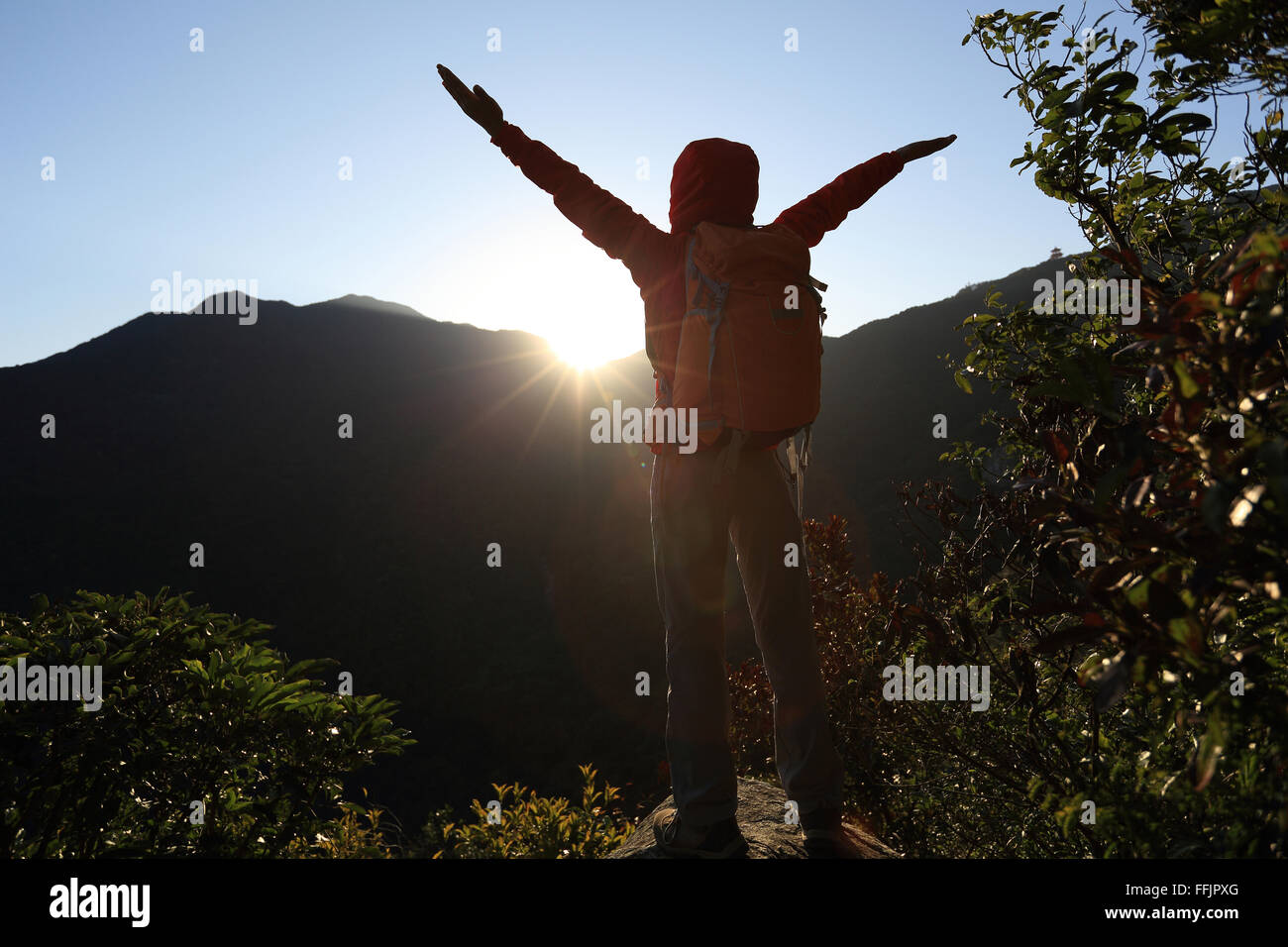 successful woman hiker open arms on sunrise mountain peak Stock Photo ...