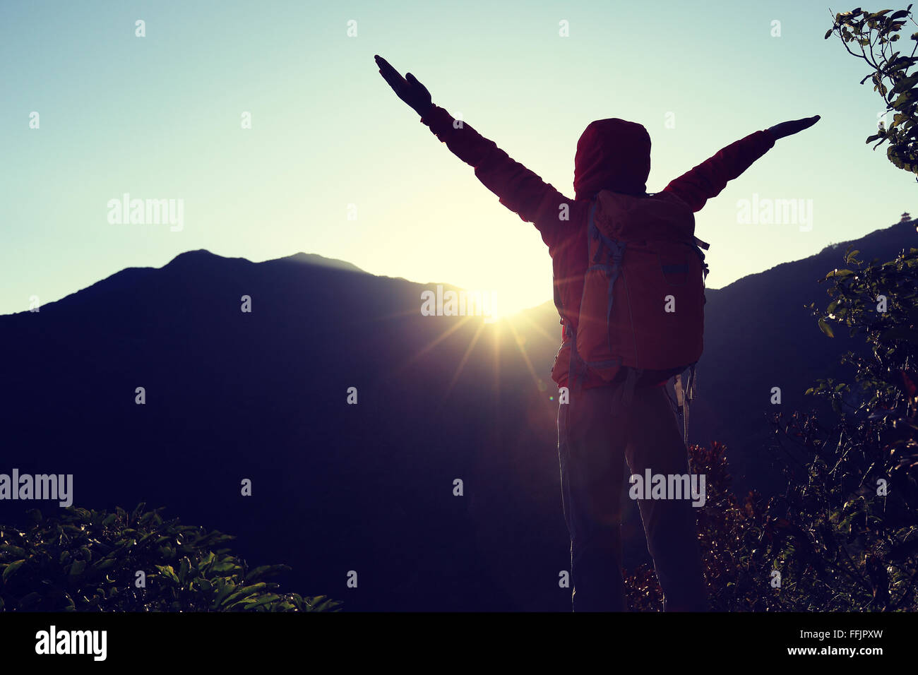 successful woman hiker open arms on sunrise mountain peak Stock Photo ...