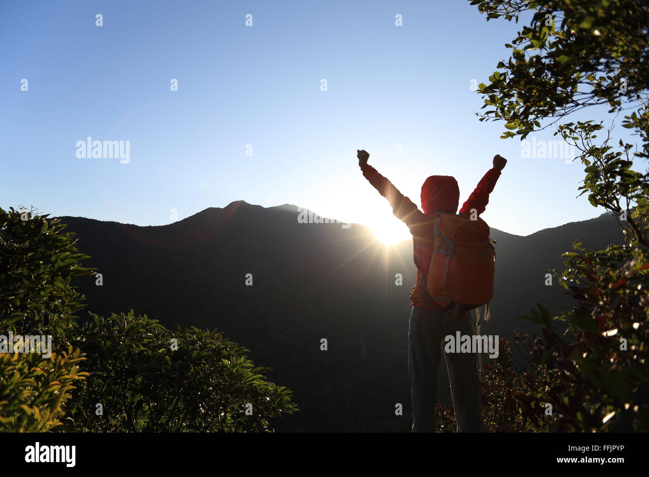 successful woman hiker open arms on sunrise mountain peak Stock Photo ...