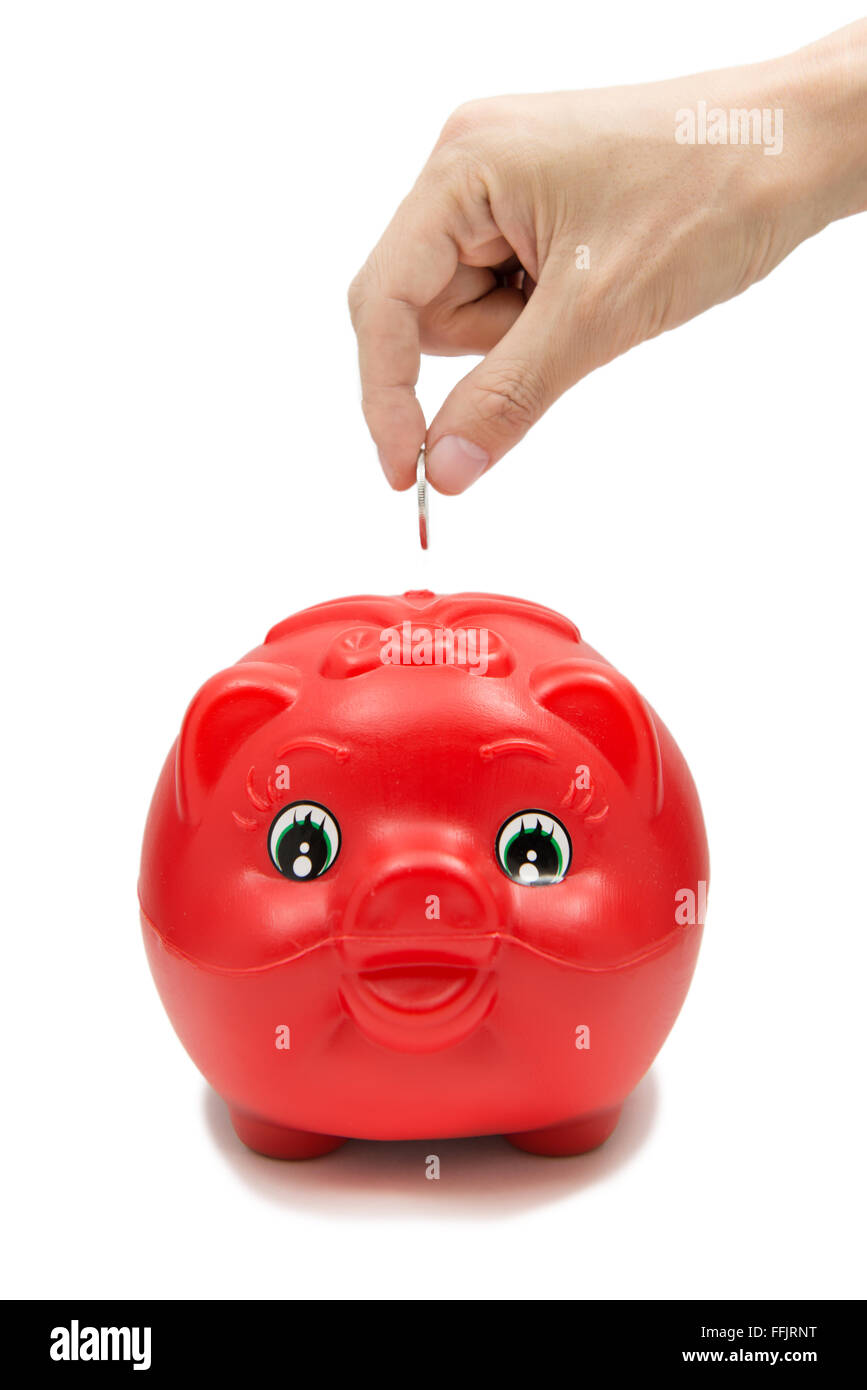 Hand inserting coin into piggybank isolated on white background Stock ...