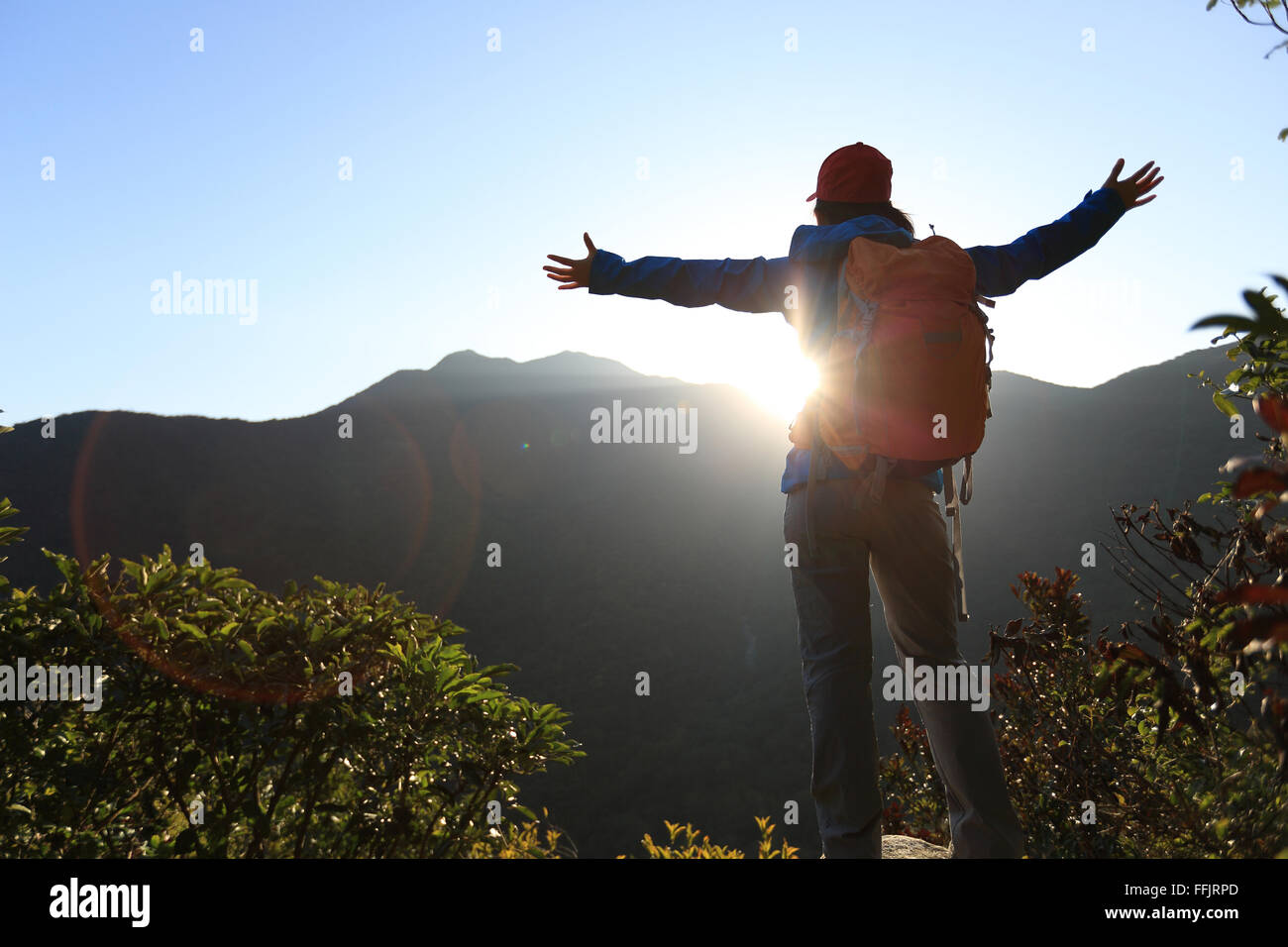 successful woman hiker open arms on sunrise mountain peak Stock Photo ...