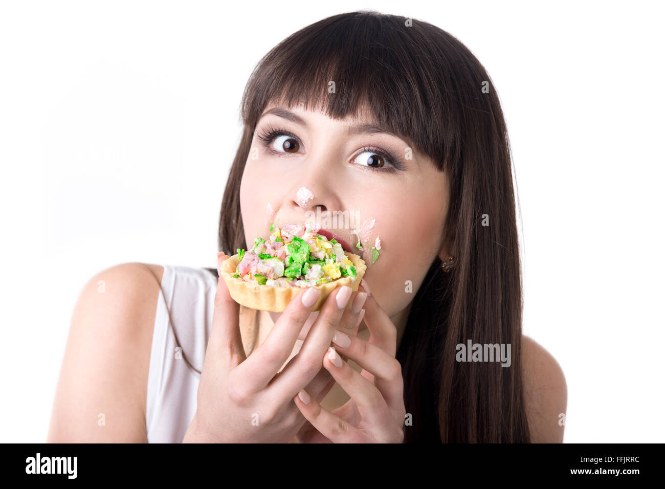 Young beautiful hungry woman eating very delicious tart cake with ...