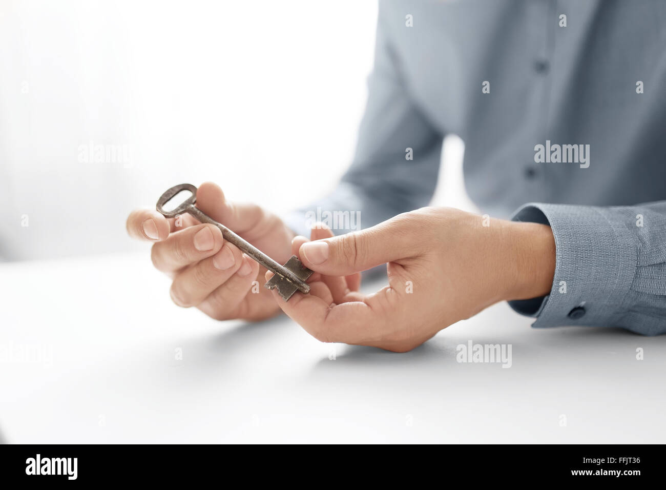 Businessman's hand holding key. Key Business Solutions. Business ...