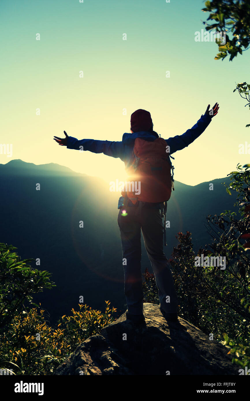 successful woman hiker open arms on sunrise mountain peak Stock Photo ...