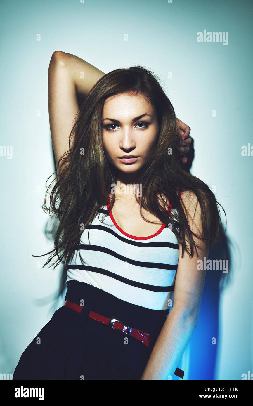 Modern young woman posing in studio Stock Photo - Alamy