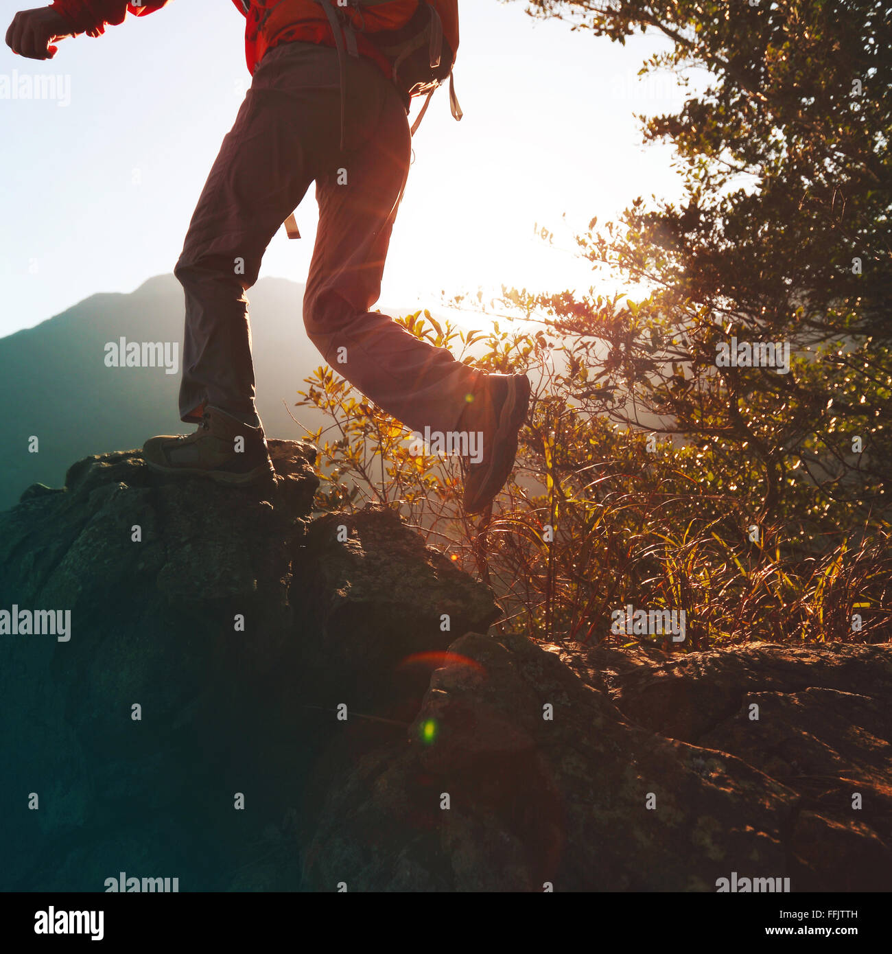young woman hiker hiking on sunrise mountain peak Stock Photo - Alamy