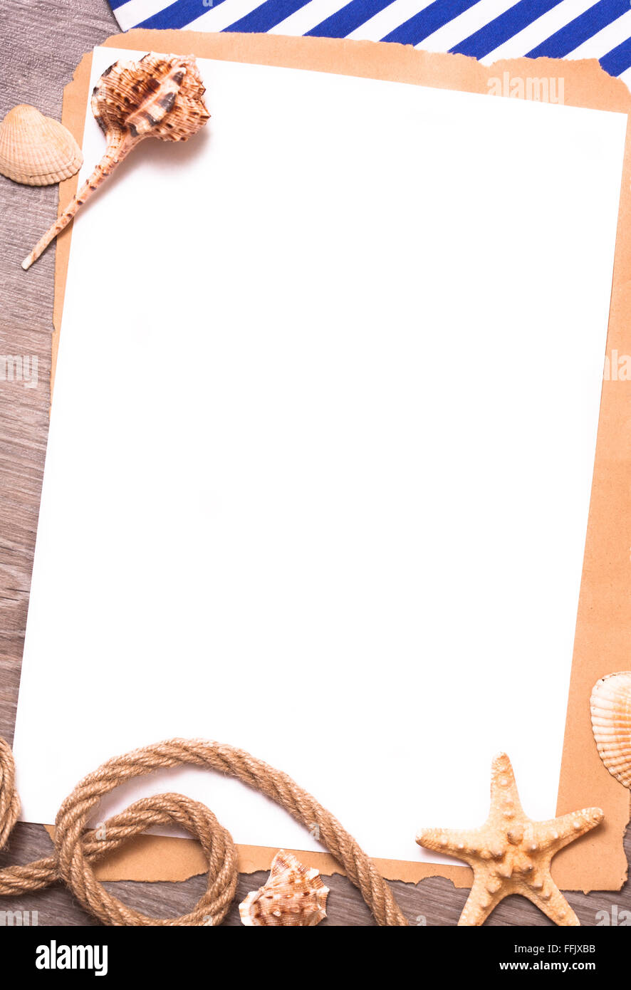 Background with a white sheet of paper, rope and shells in a marine ...