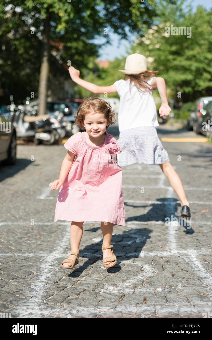 Two girls playing hopscotch hi-res stock photography and images - Alamy