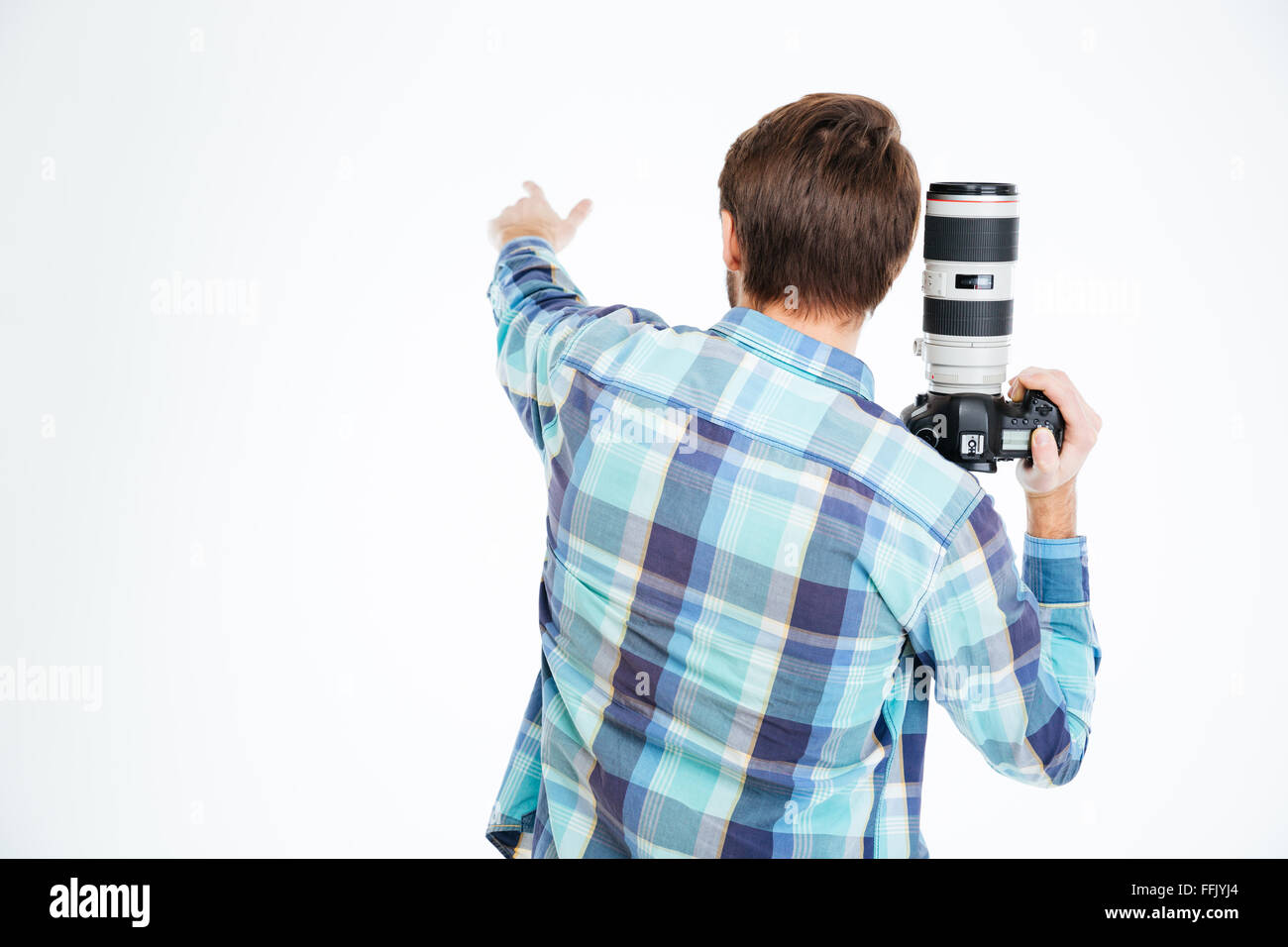 Back view portrait of a male photographer holding photo camera and ...