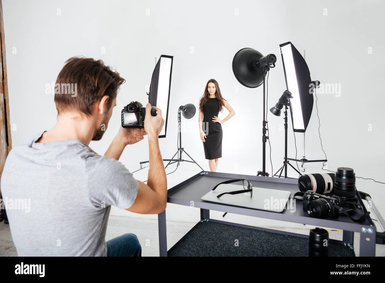 Man shooting female model in studio with equipments Stock Photo - Alamy