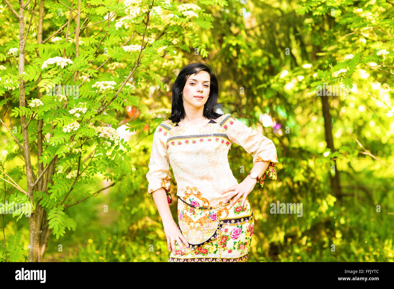 Beautiful woman standing in a park in spring or summer Stock Photo - Alamy