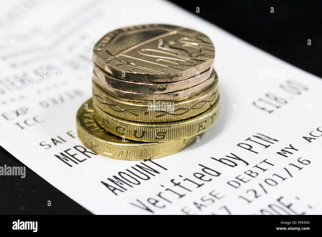 English coins/money stacked on till receipt Stock Photo - Alamy