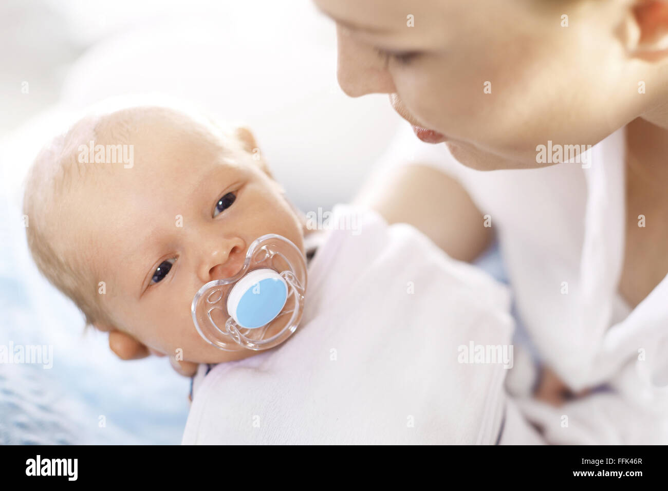 A woman holds in her arms her newborn baby . Little man, baby clinging ...