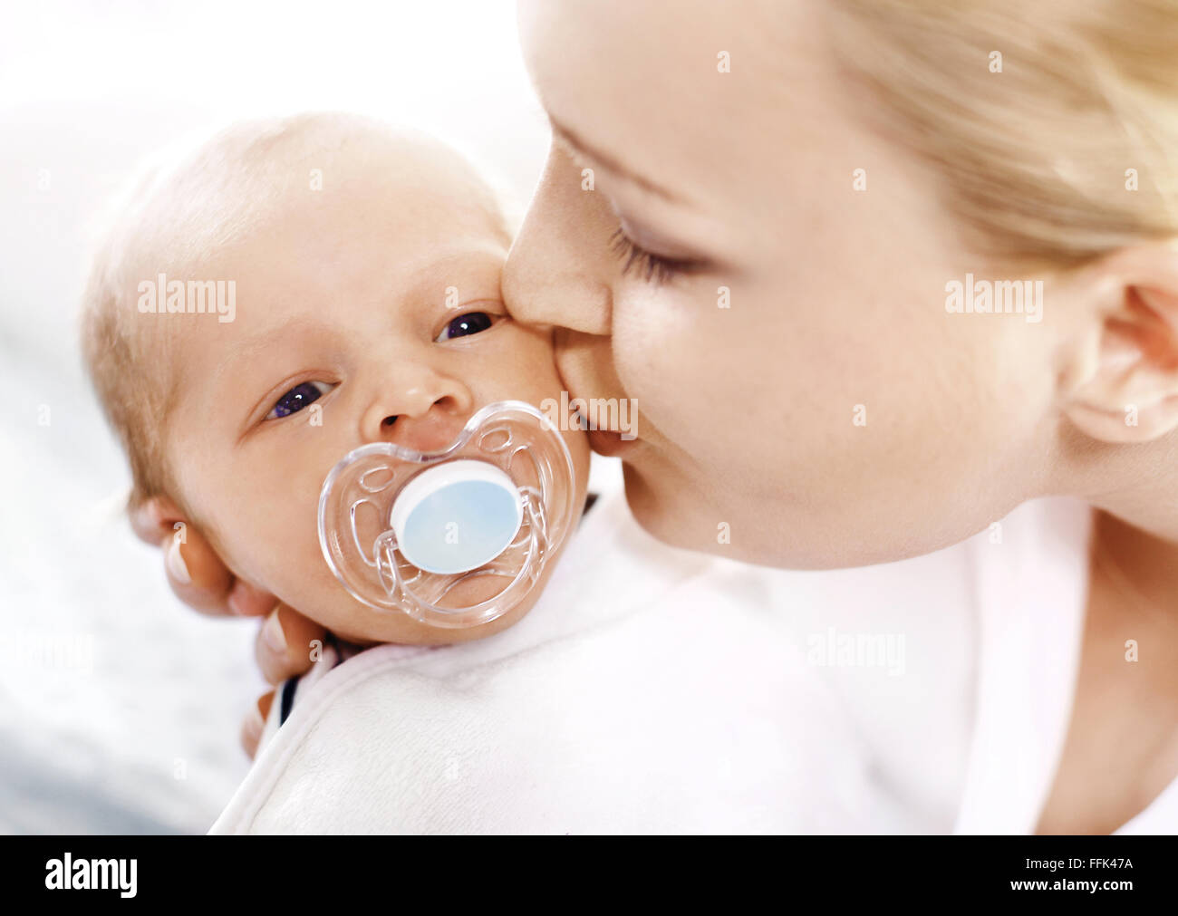 A woman holds in her arms her newborn baby . Little man, baby clinging ...