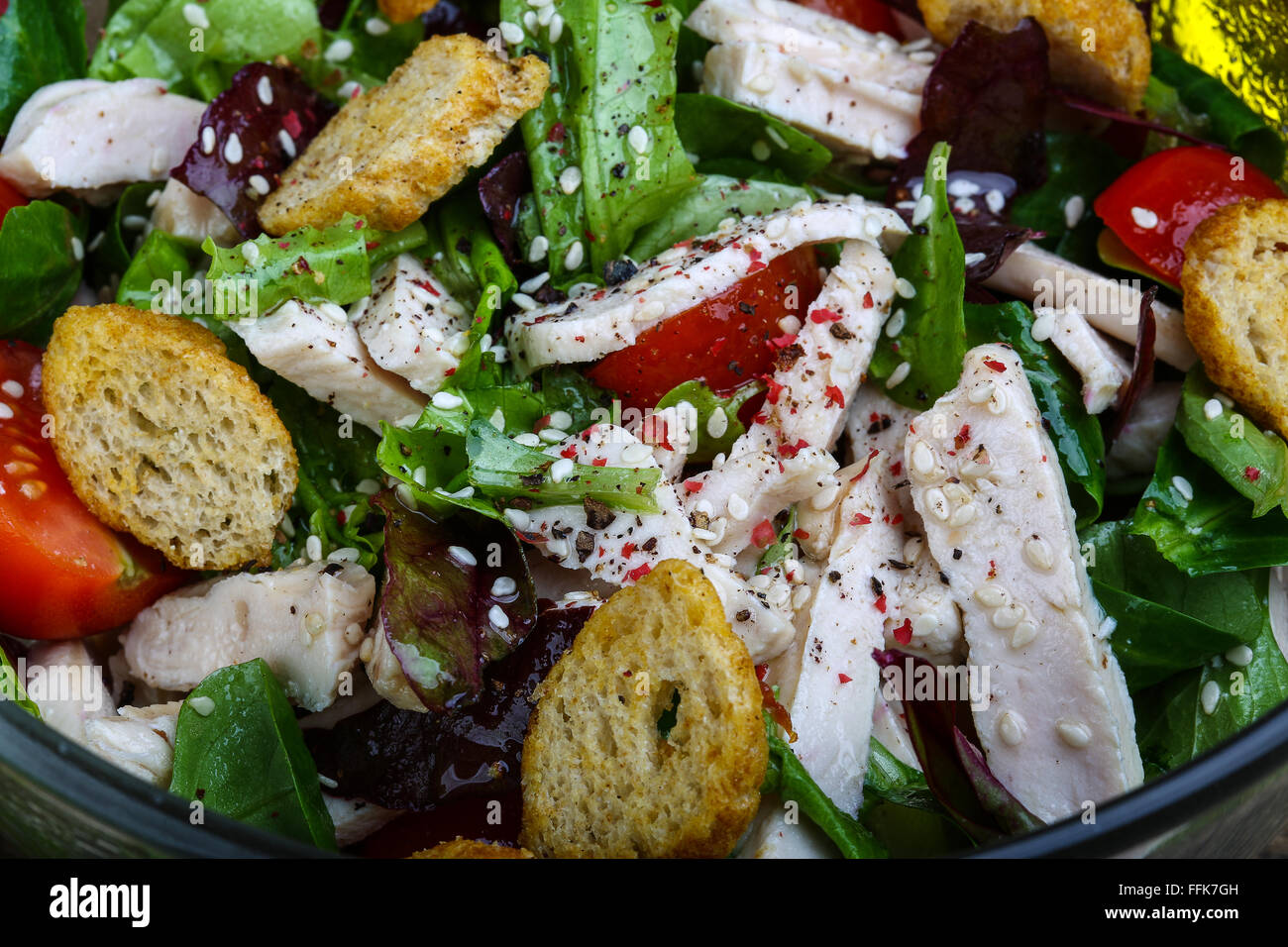 Caesar salad with chicken, tomato and sesam seeds Stock Photo - Alamy