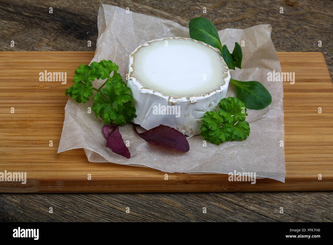 Goat cheese with white mold served parsley leaves Stock Photo - Alamy