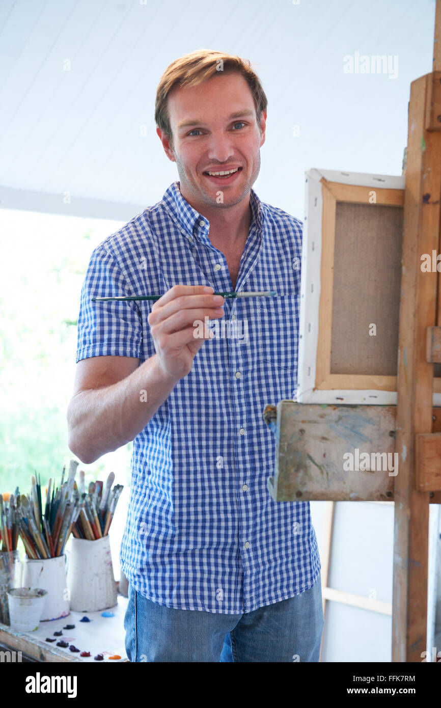 Male Artist Painting In Studio Stock Photo - Alamy
