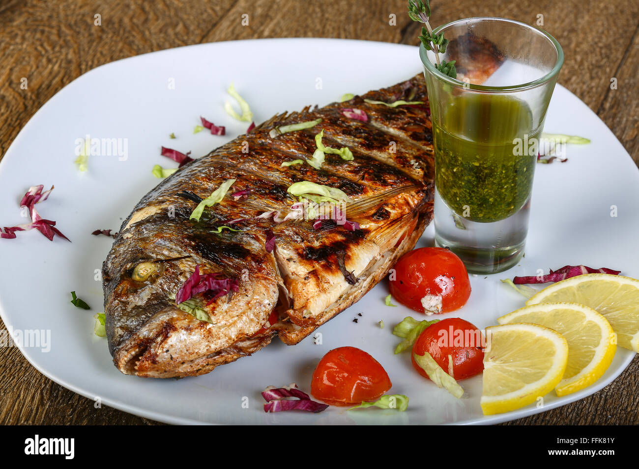 Grilled dorada with lemon, tomato and thyme sauce Stock Photo - Alamy