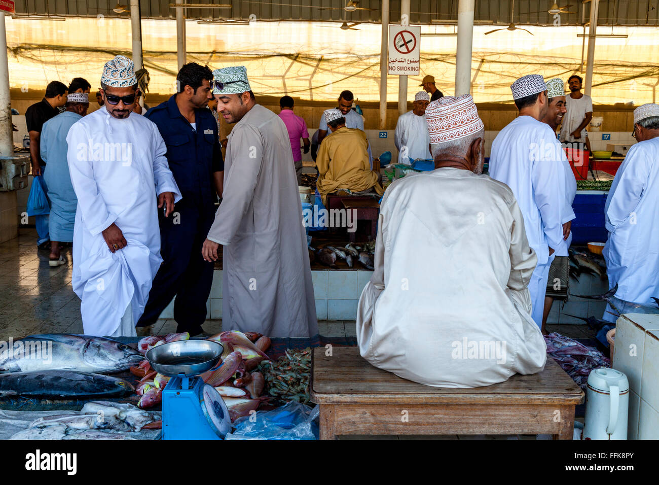 Omani Men In Traditional Dress Buying Fish At The Fish Market, Muttrah ...