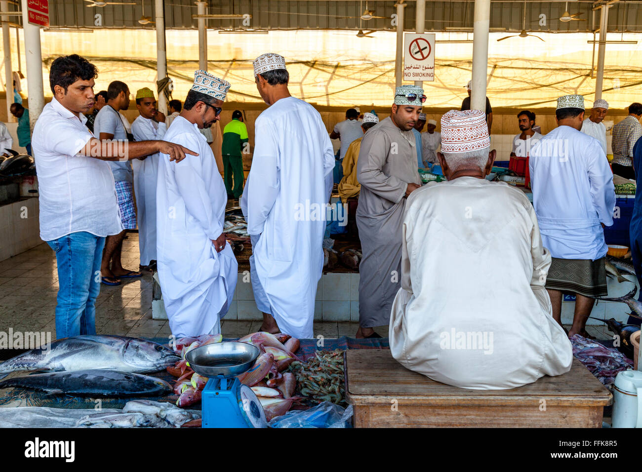 Omani Men In Traditional Dress Buying Fish At The Fish Market, Muttrah ...