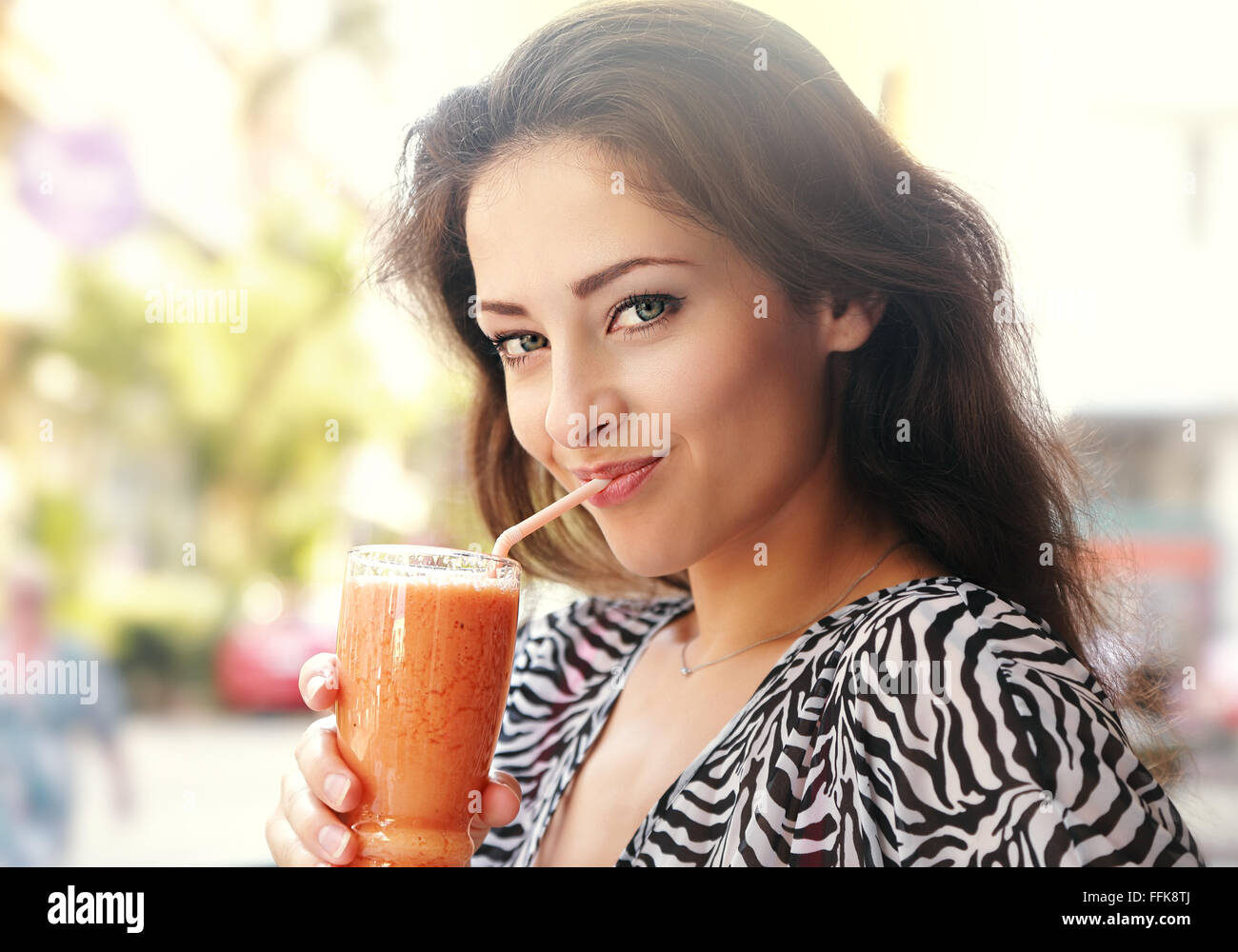 Beautiful happy young woman drinking healthy smoothie juice outdoor ...