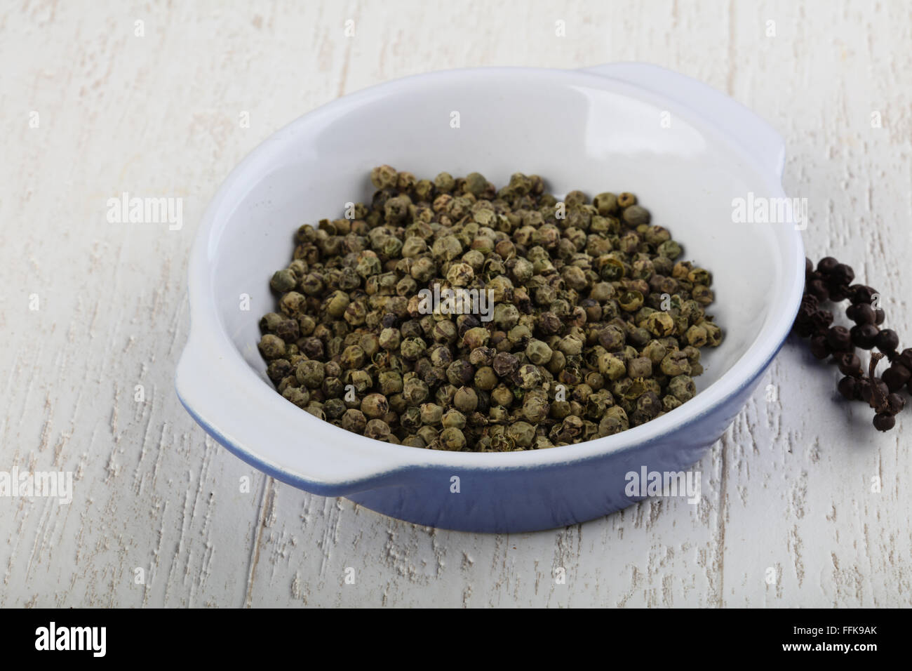 Dry Green pepper corn on the wood background Stock Photo - Alamy