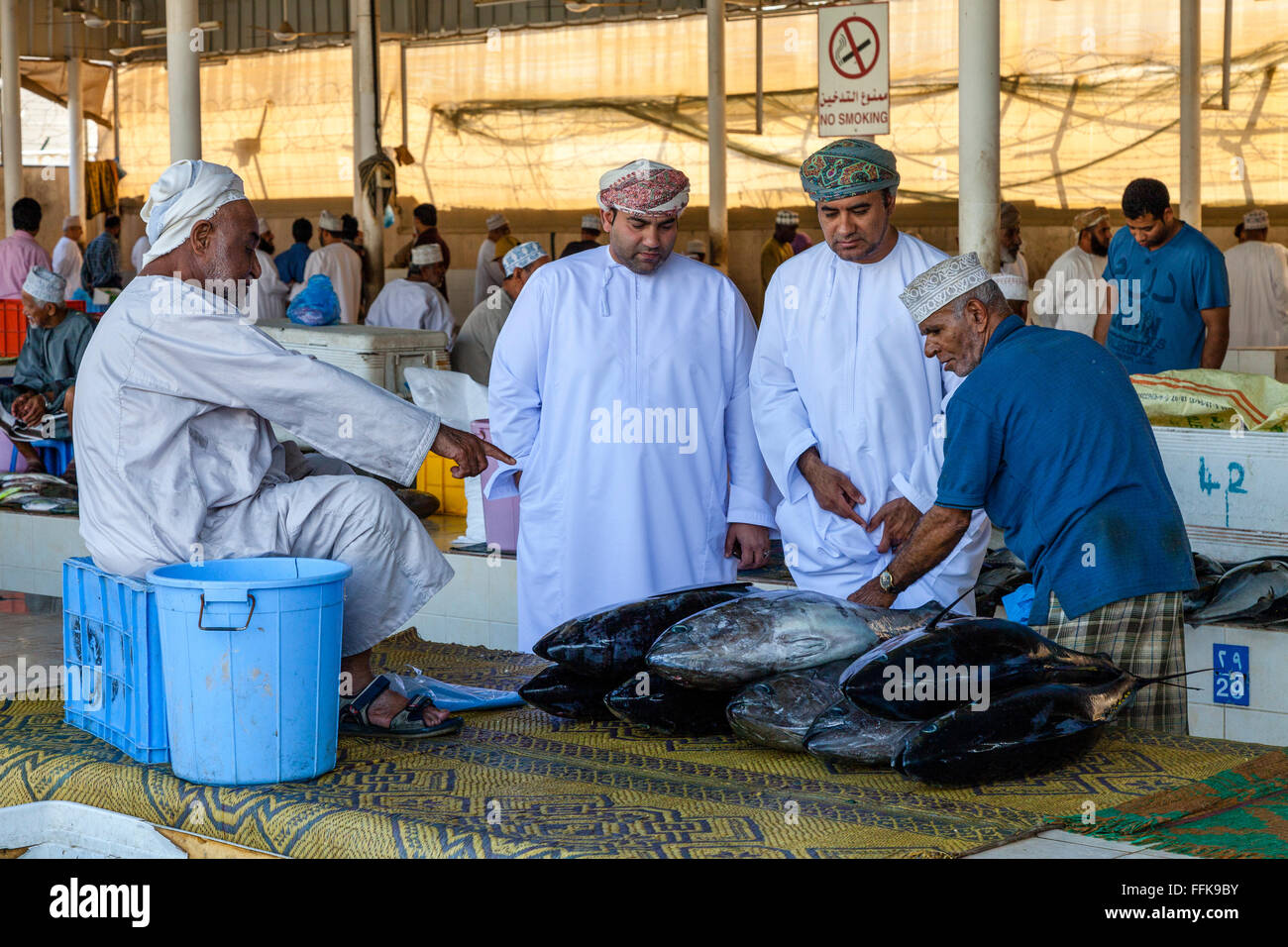 Omani Men In Traditional Costume Buy Fresh Fish At The Fish Market ...