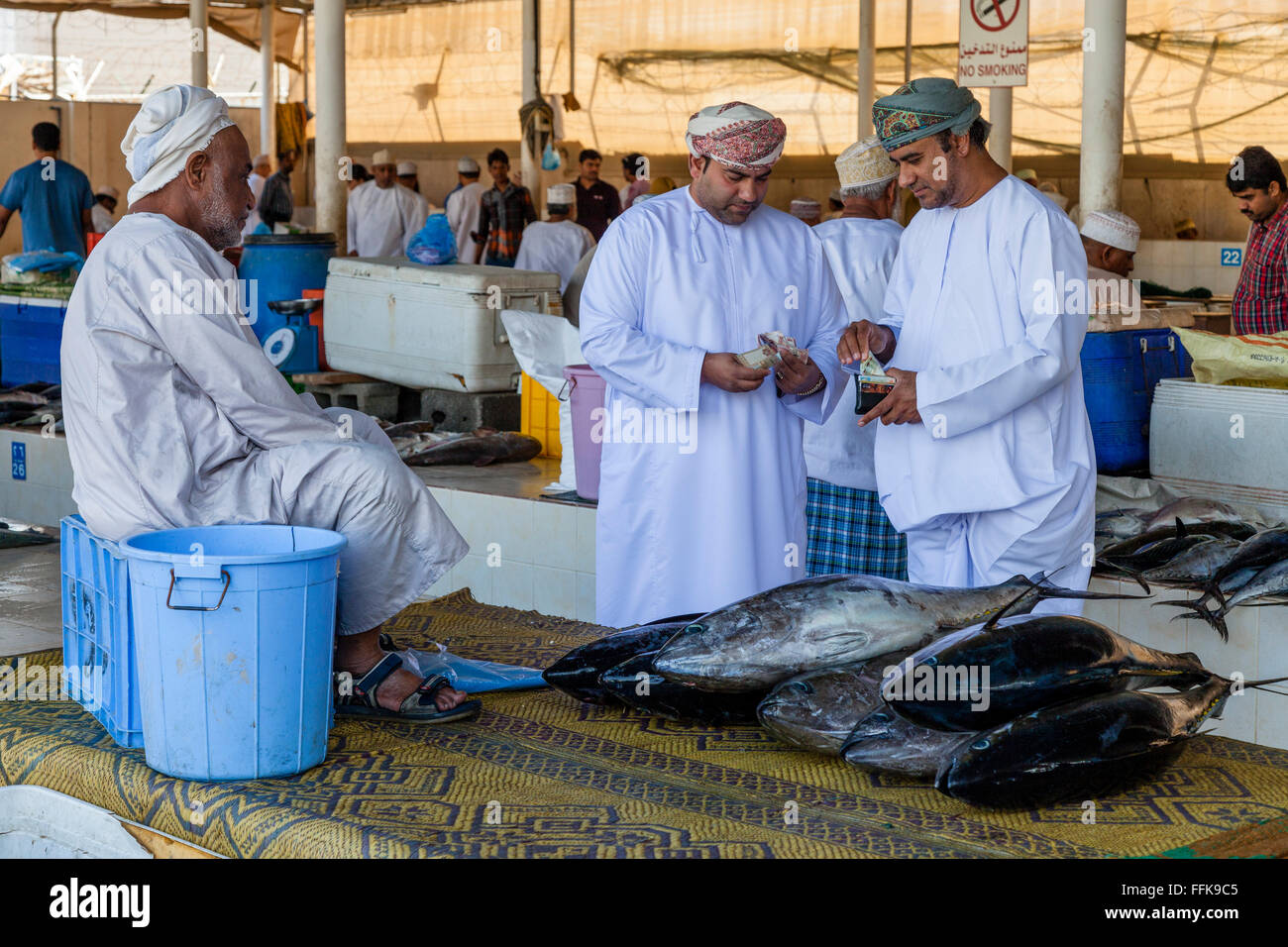 Omani Men In Traditional Costume Buy Fresh Fish At The Fish Market ...