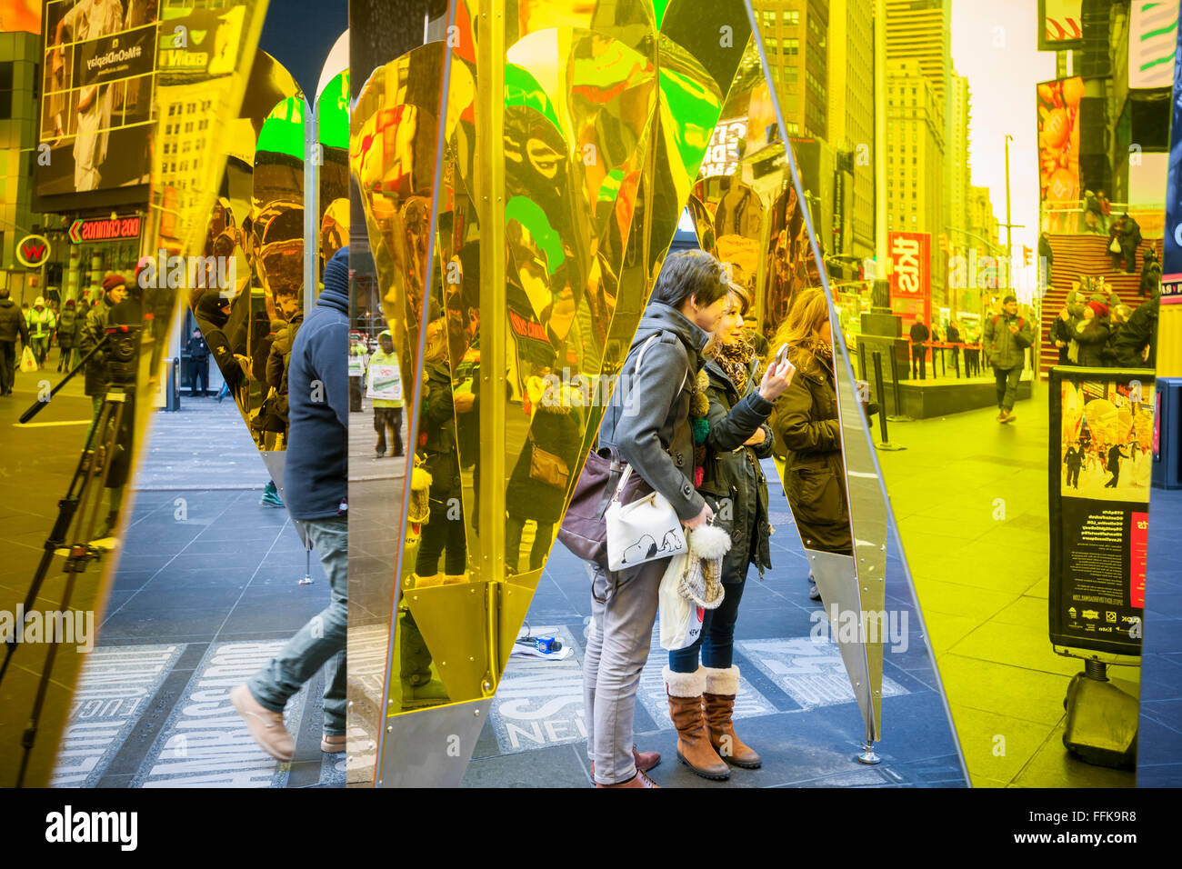 Visitors view their reflections in "Heart of Hearts", the winner of the ...