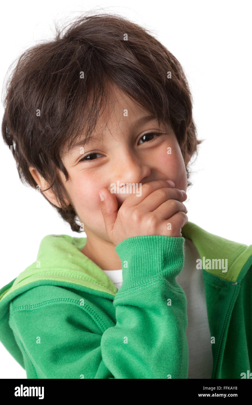 Little boy laughing behind his hand on white background Stock Photo - Alamy