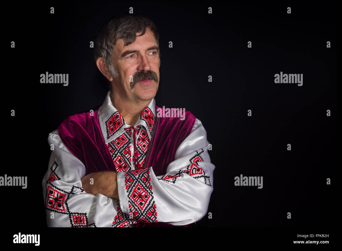 Indoor portrait of mature Ukrainian country-man in traditional clothes ...