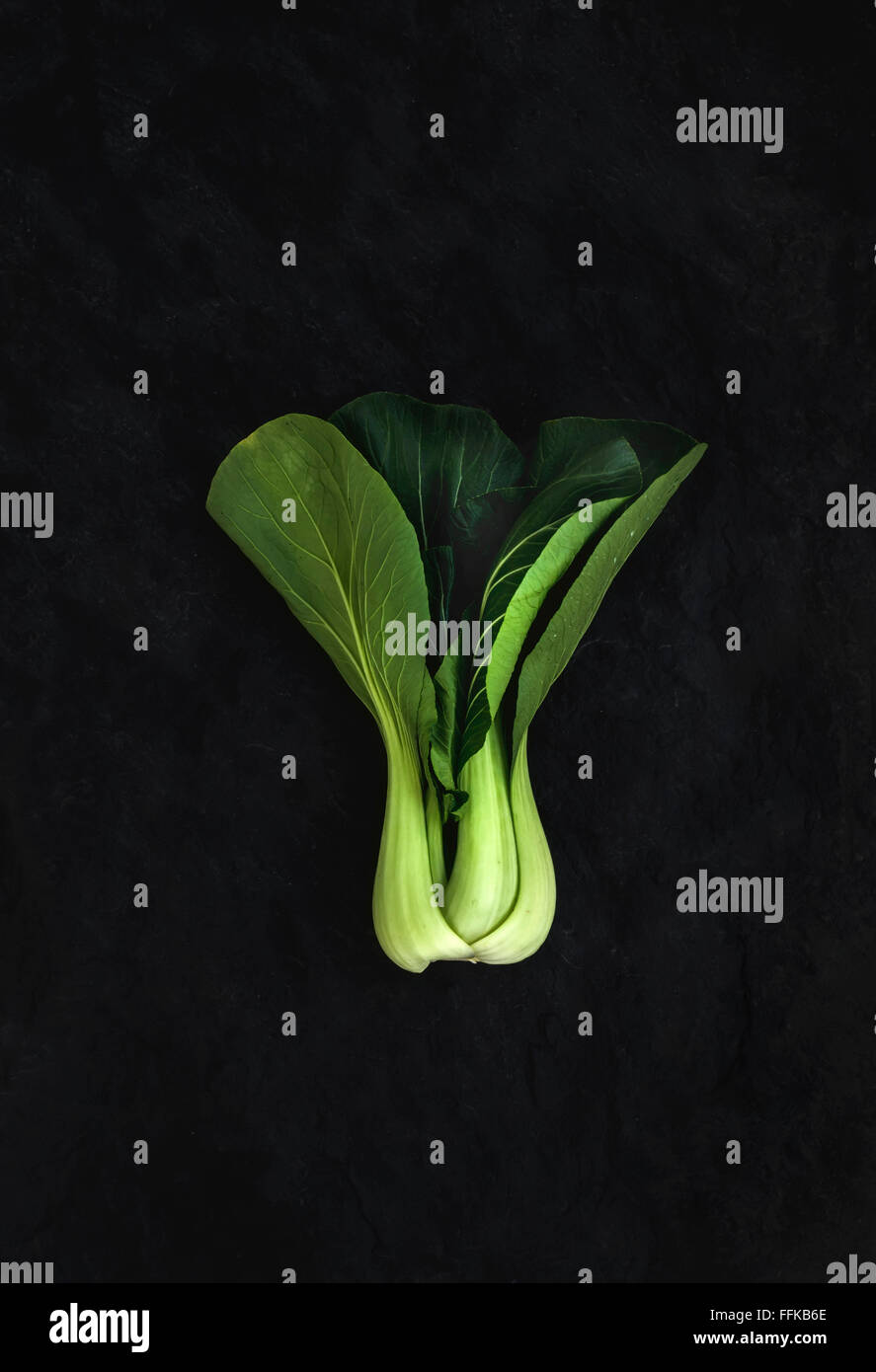 Pak choi on slate stone black background, top view Stock Photo - Alamy