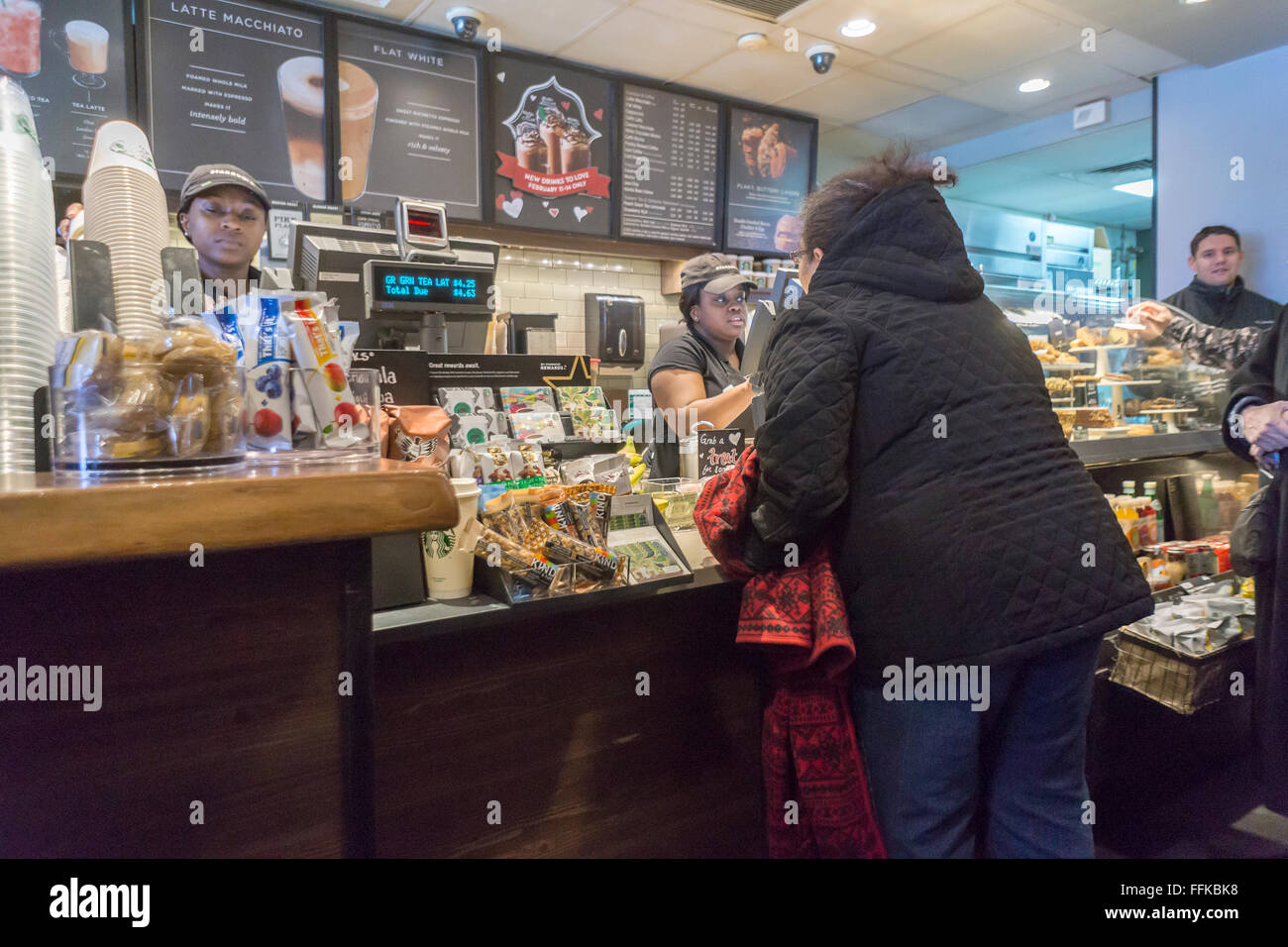 Customers in a busy Starbucks in Queens in New York on Saturday ...