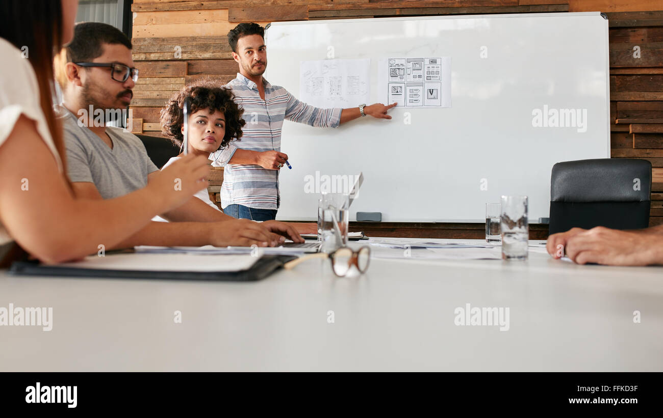 Young african woman sitting at conference table during a business ...